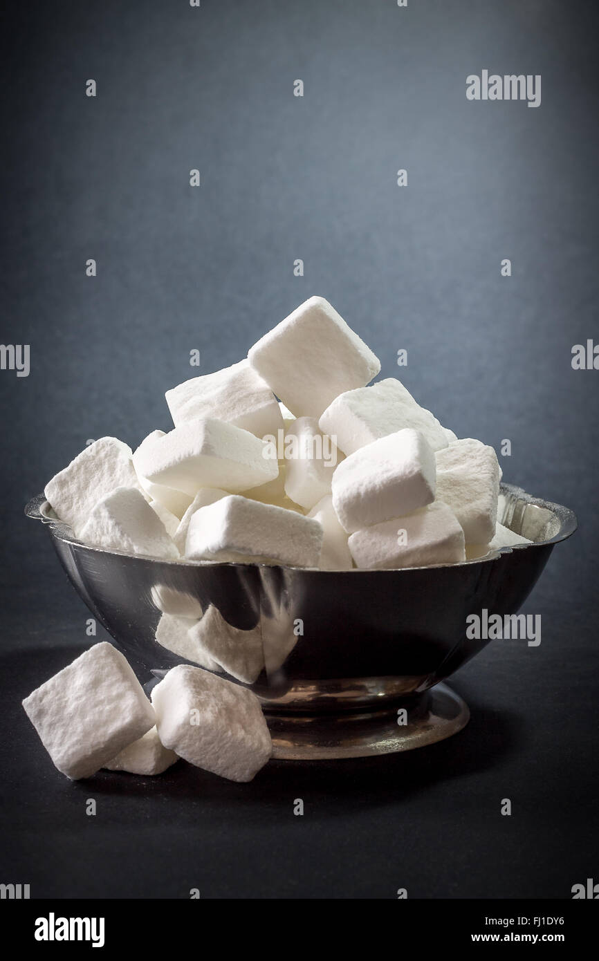 Sugar in metallic bowl on dark background. Copy space Stock Photo - Alamy