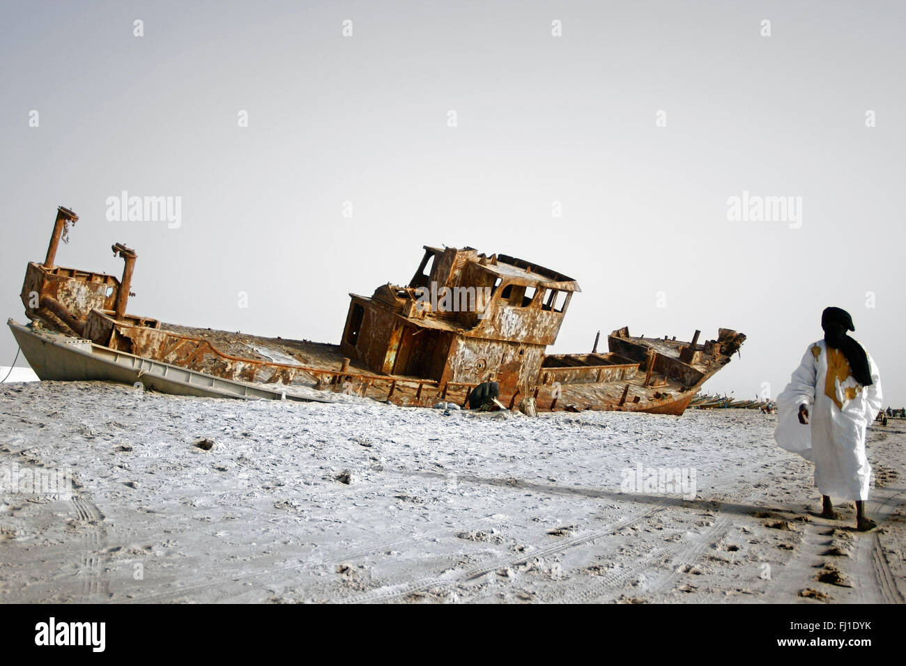 Old rust rusty boat on the beach and traditional harbor of Nouakchott ...