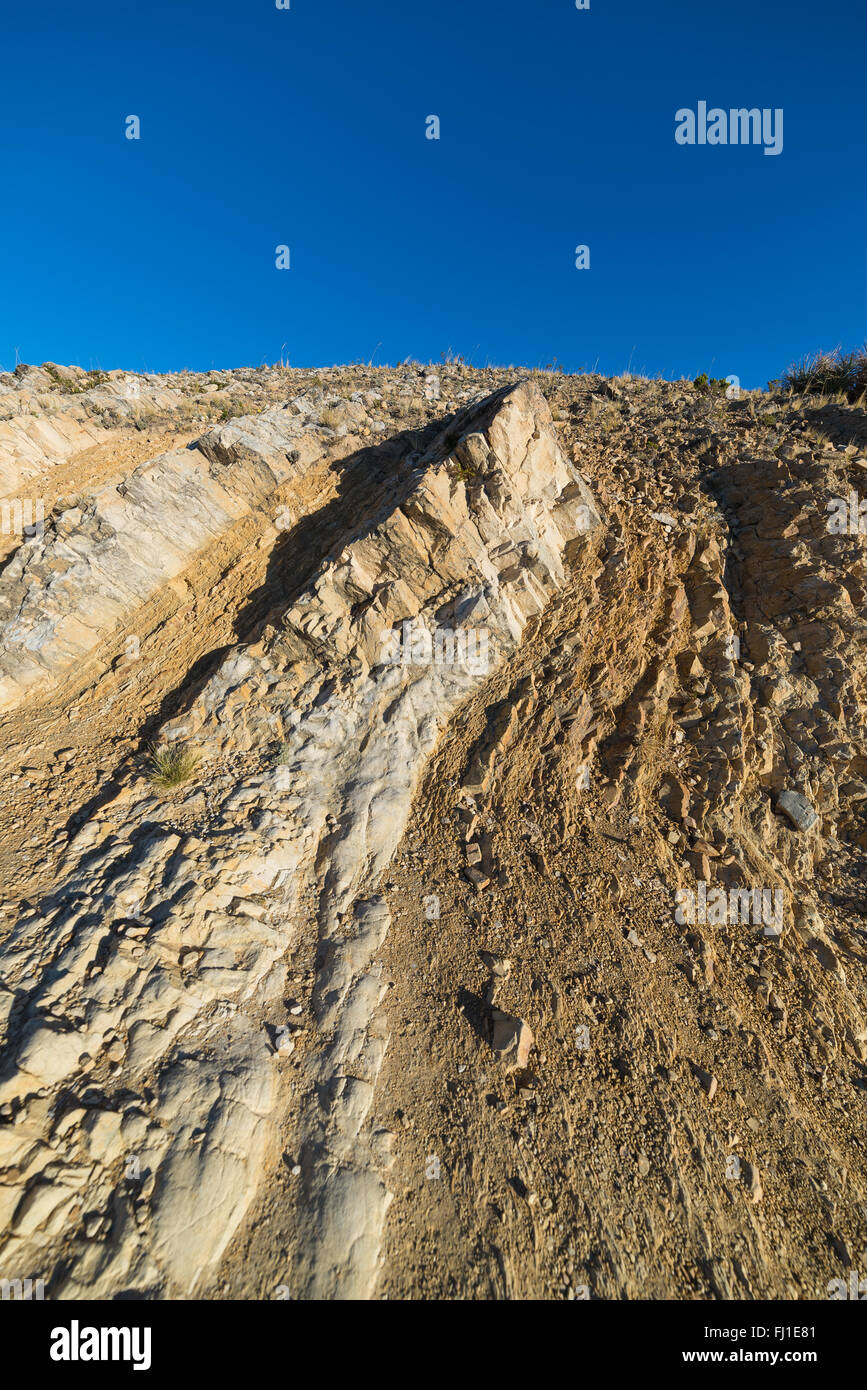 Close up of ancient sedimentary layered rock outcrop, folded by the ...
