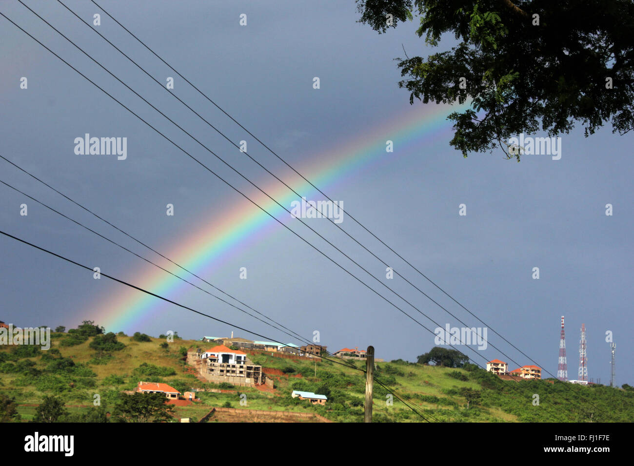 A rainbow cuts across the Ugandan sky in Uganda Stock Photo - Alamy