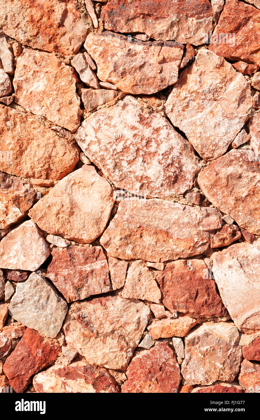 Full frame, close up image of of variously tones of red sand stone ...