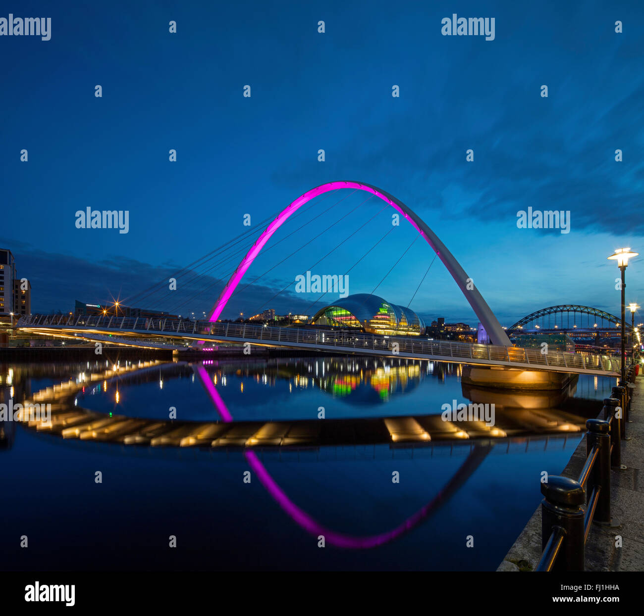 a night view of gateshead millennium bridge reflected in the river tyne ...