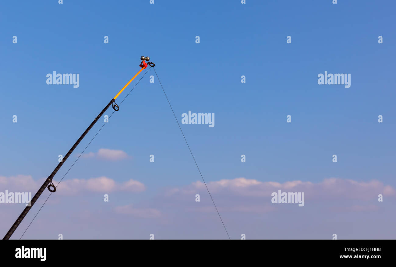 Top fishing rod on blue sky Stock Photo - Alamy