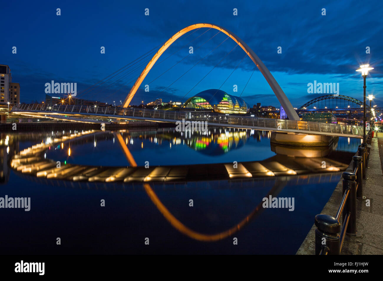 a night view of gateshead millennium bridge reflected in the river tyne ...