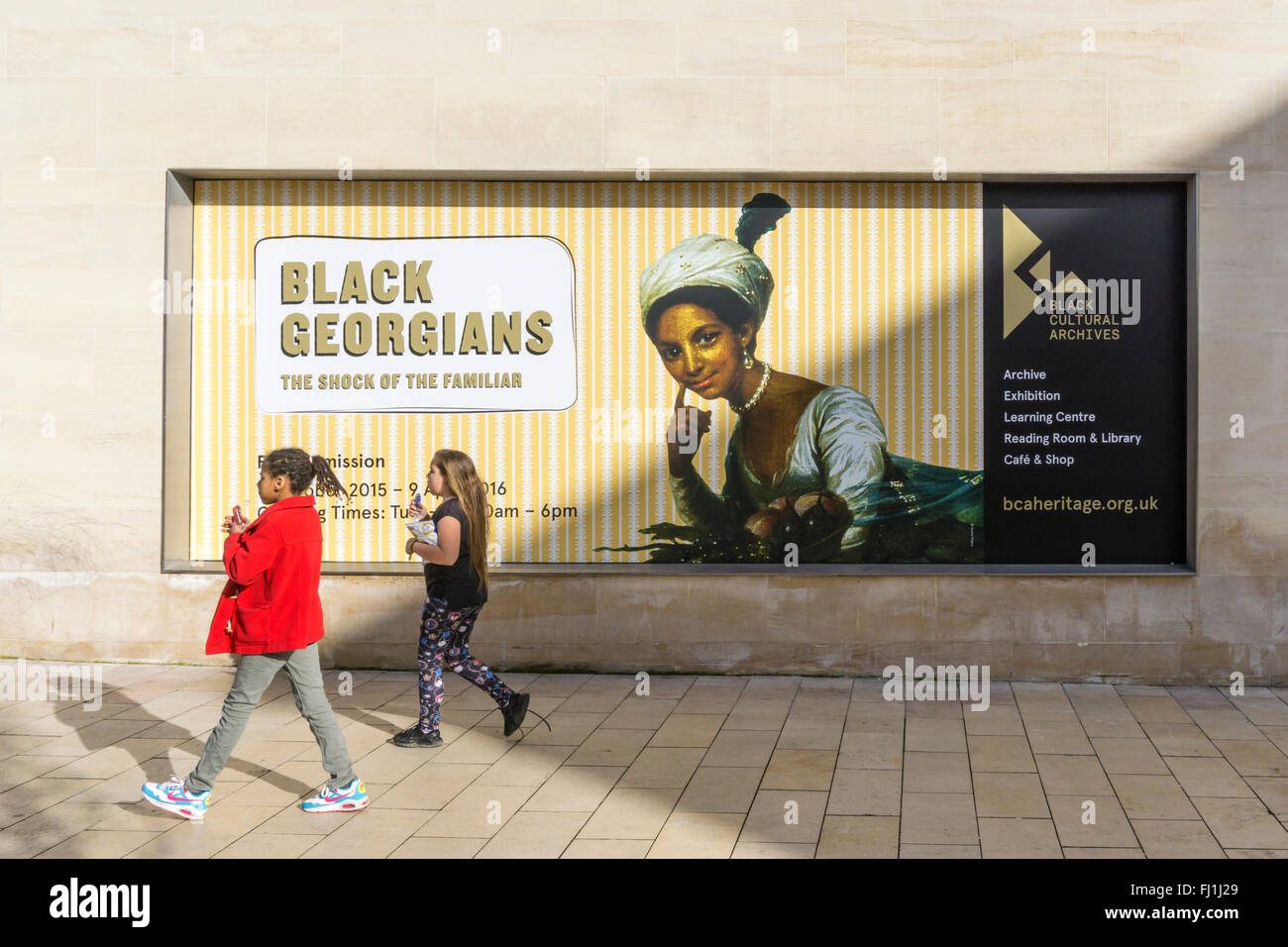 Two girls passing poster for Black Georgians exhibition, featuring Dido ...