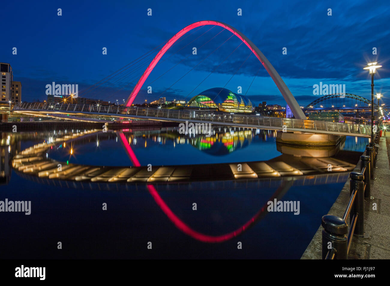 a night view of gateshead millennium bridge reflected in the river tyne ...