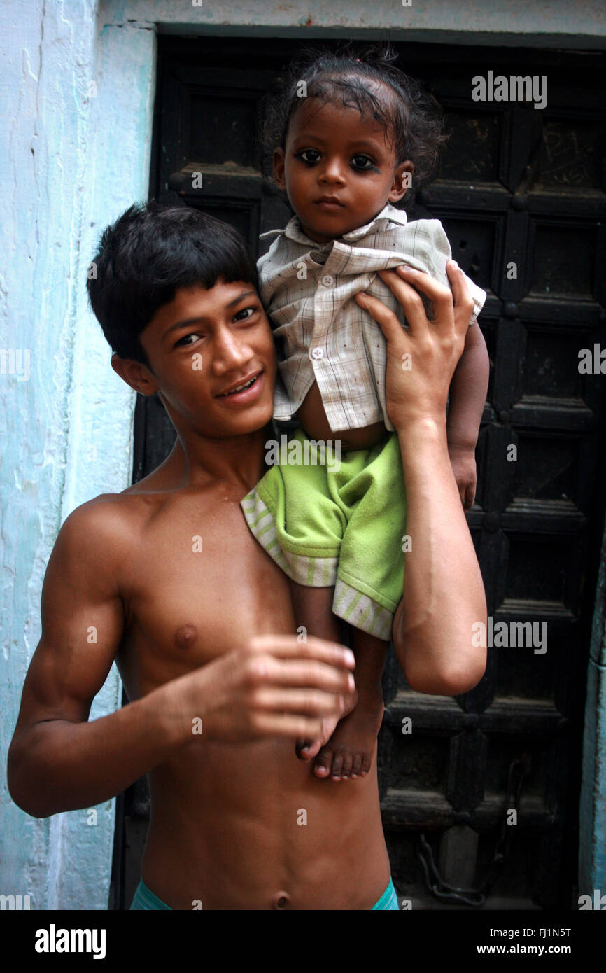 Young fit guy carries his brother on his shoulder, wearing kohl on his ...