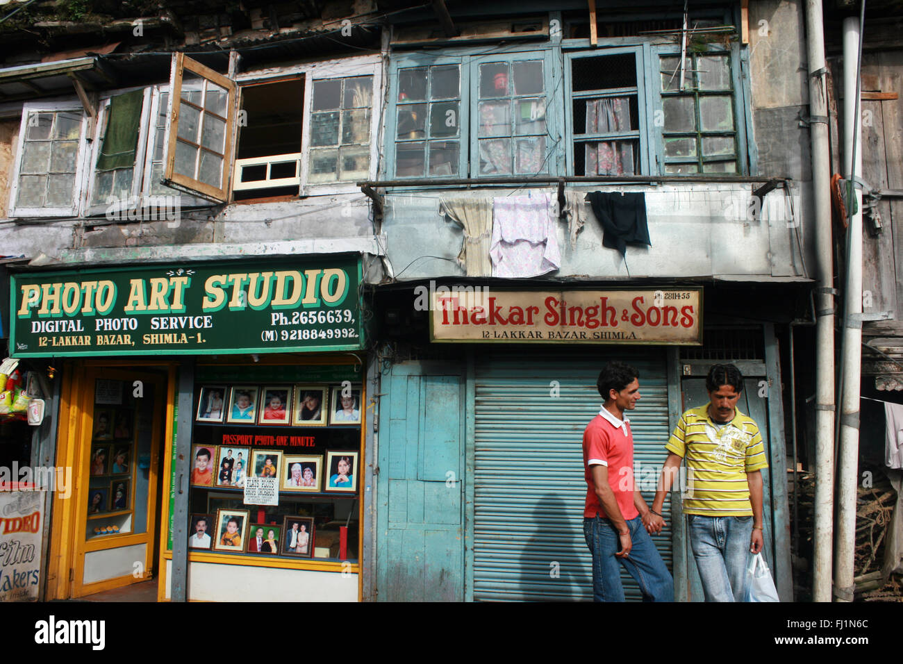 Two men walk together hand in hand in a street of Shimla , India Stock ...