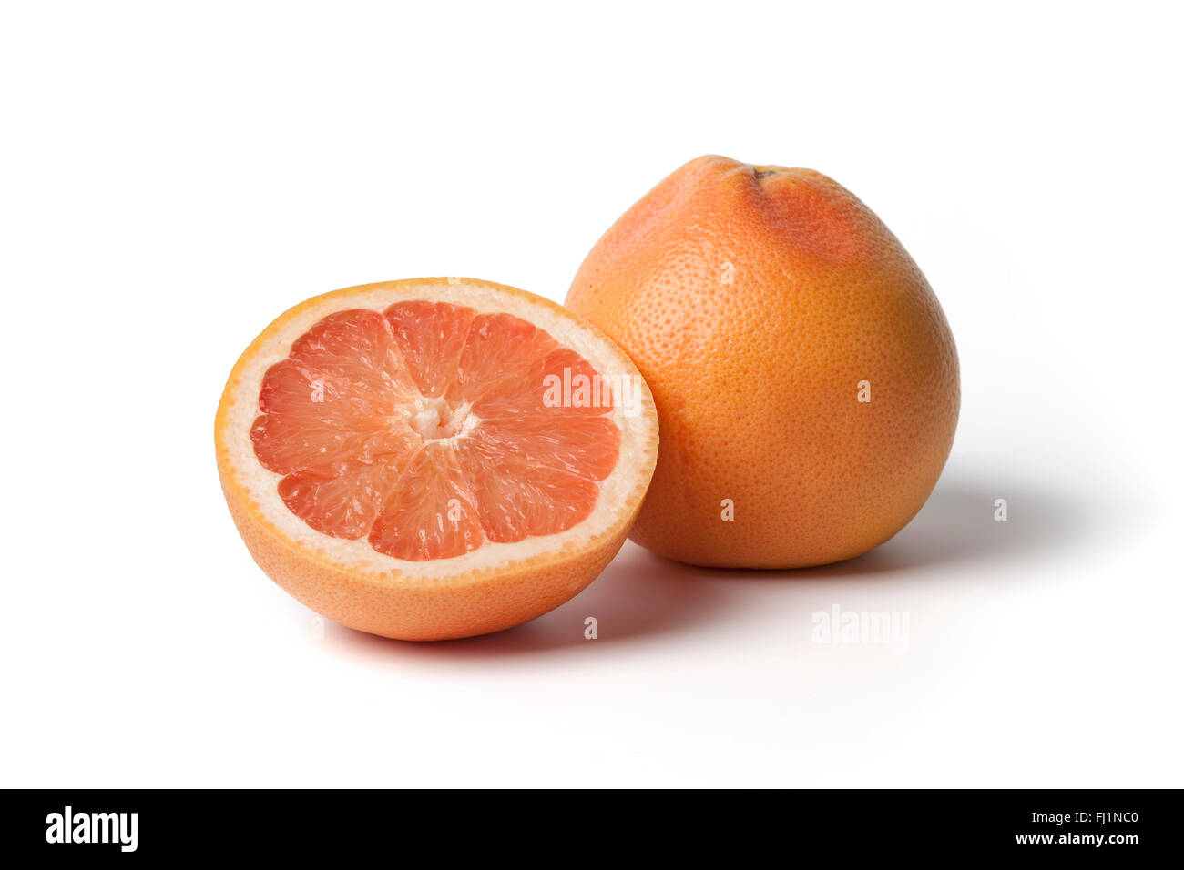 Whole and half fresh ripe grapefruit on white background Stock Photo ...