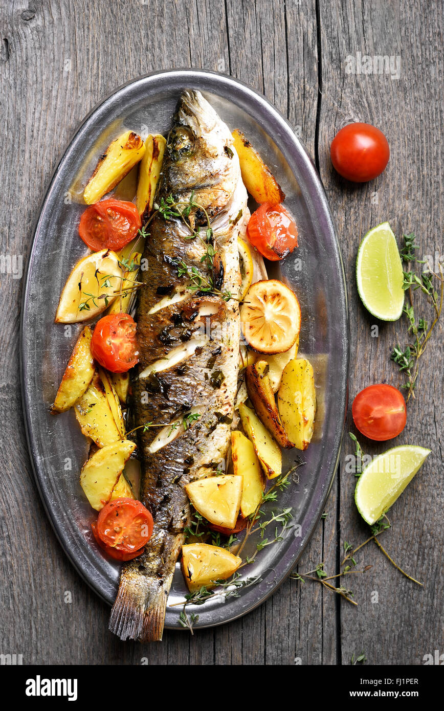 Grilled fish with baked potato wedges, top view Stock Photo - Alamy