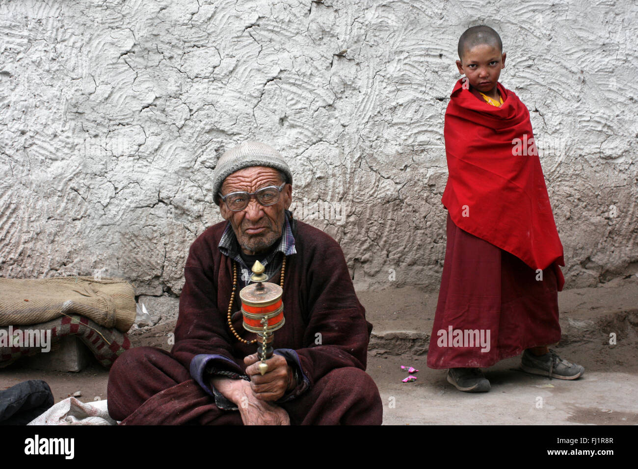 Old man and young monk during celebrations at Hemis monastery gompa ...