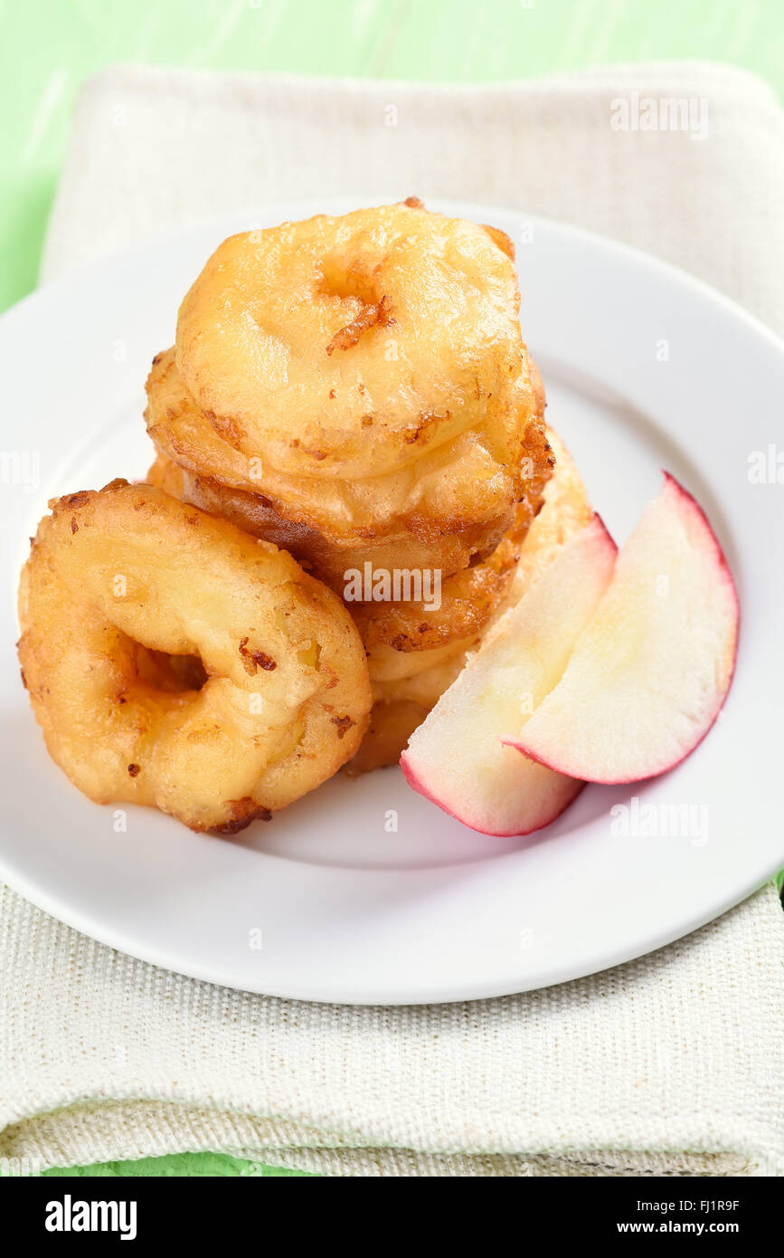 Apple donuts and slices on white plate Stock Photo - Alamy