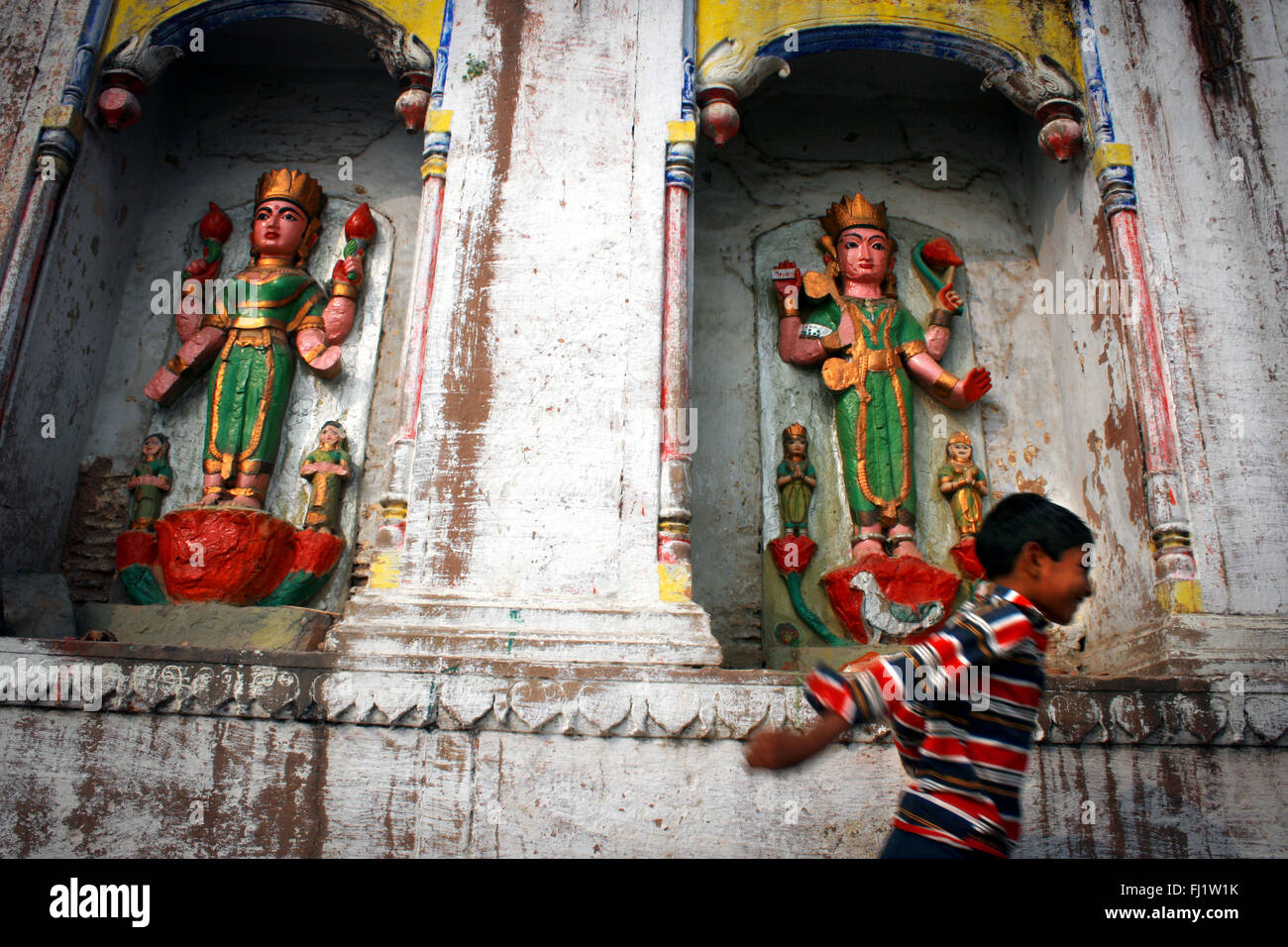 Kid runs along a temple on a ghat of Varanasi, India Stock Photo - Alamy