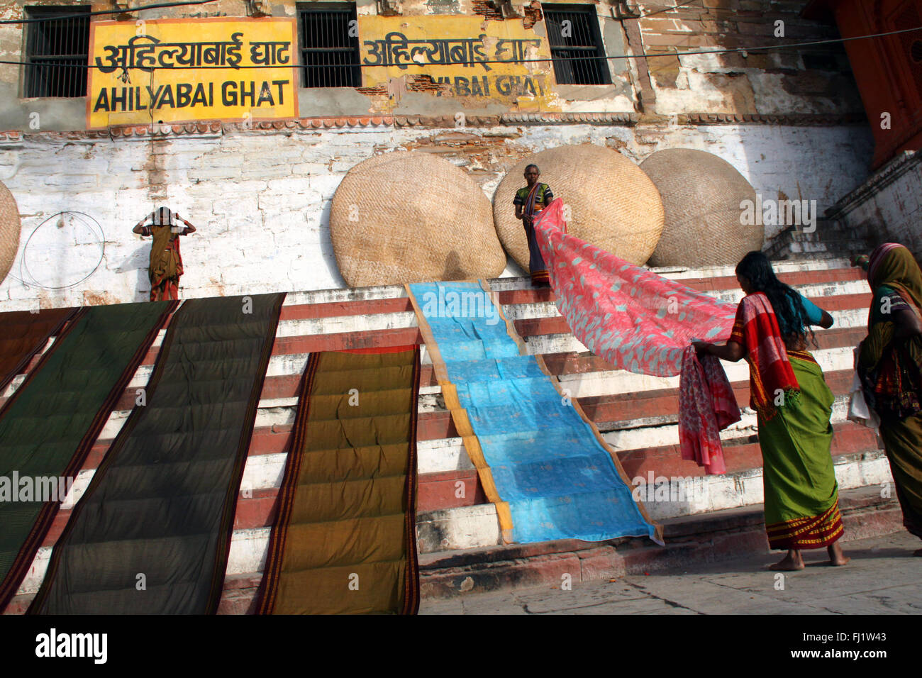 Women make their sarees dry on the banks of the ganges on the ghats of ...