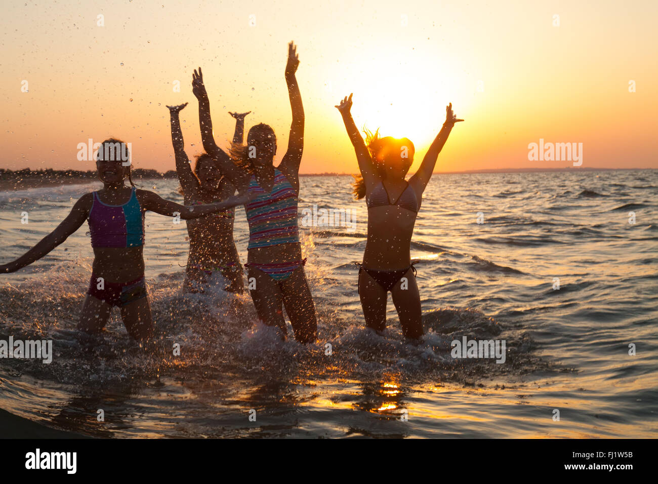 Teenagers jumping into water hi-res stock photography and images - Alamy
