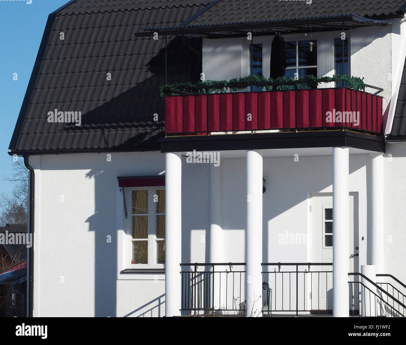 The red balcony. A red balcony on a white swedish house Stock Photo - Alamy