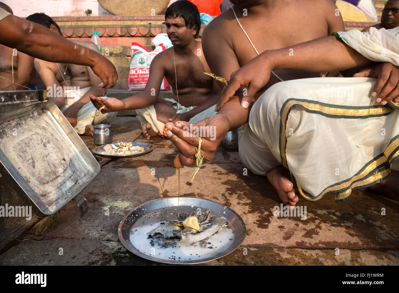 People make puja ritual on a ghat in Varanasi , India Stock Photo - Alamy
