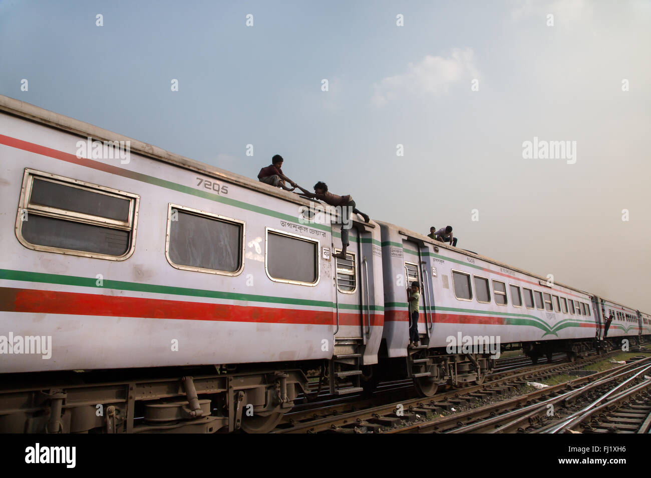 Kids travelling on the roof of a train at Dhaka railway station ...