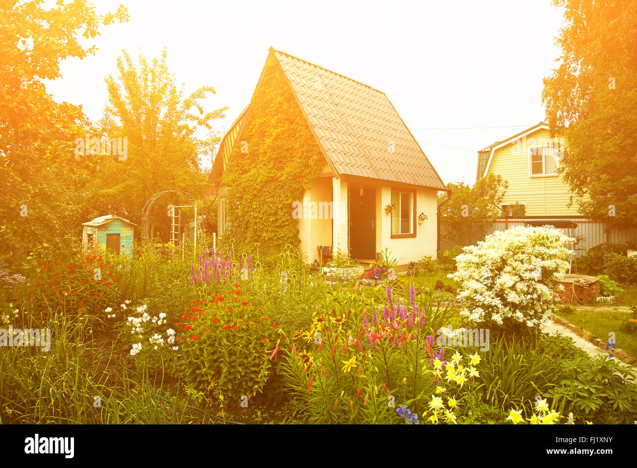 rustic country house in the lush garden Stock Photo - Alamy