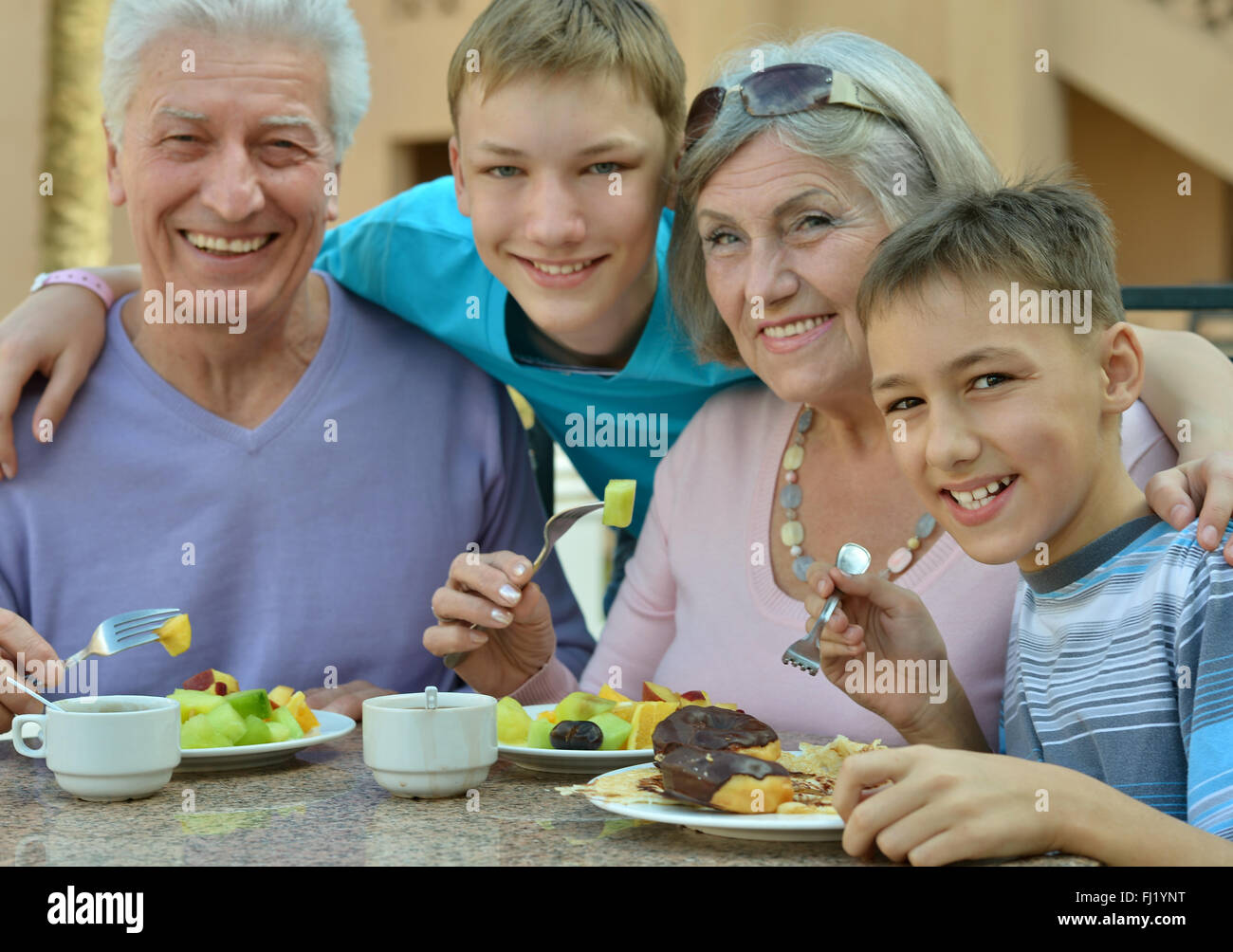 Grandparents with grandchildren at breakfast Stock Photo - Alamy