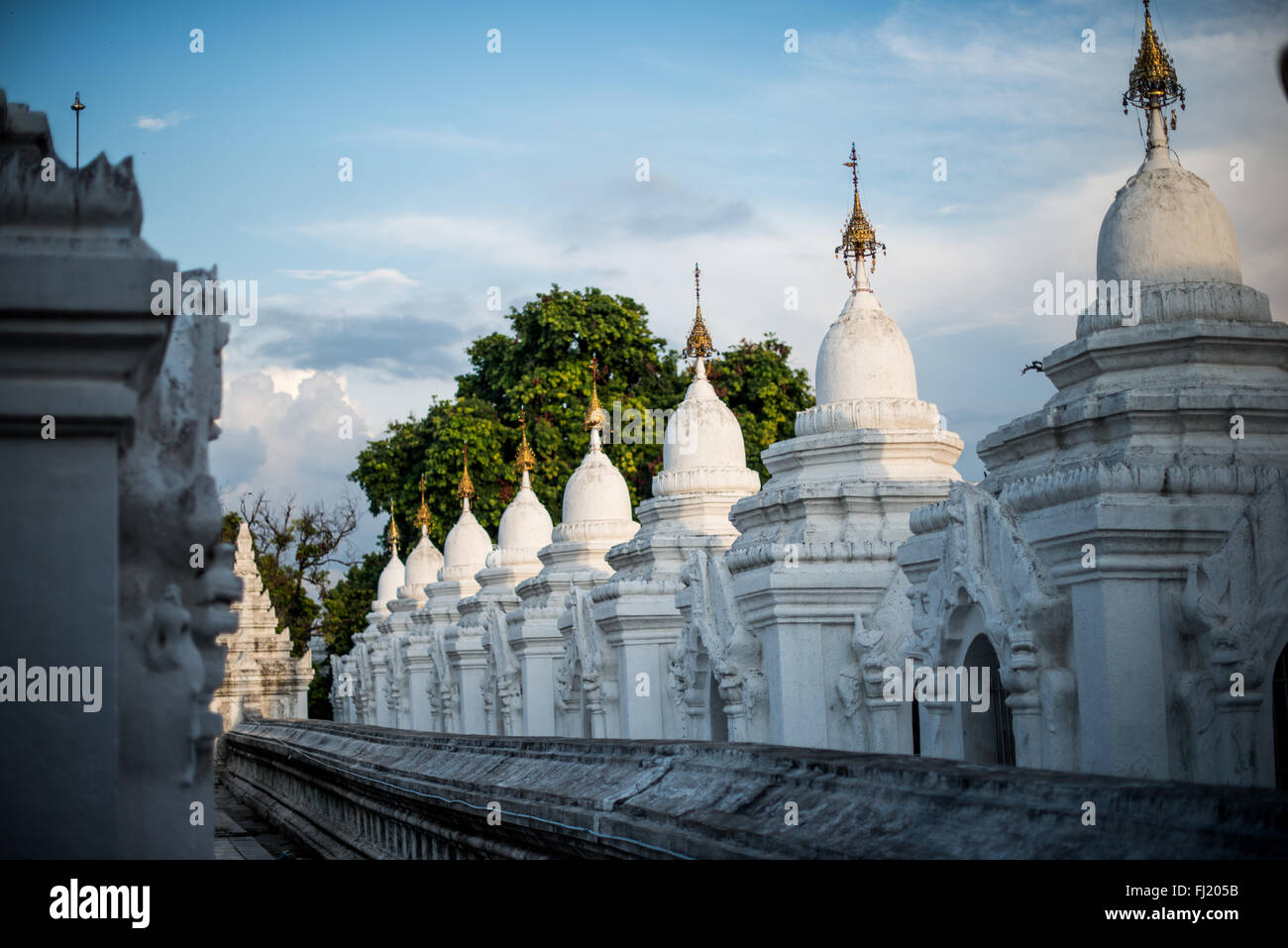 MANDALAY, Myanmar — Rows of white kyauksa gu (stone-inscription caves ...