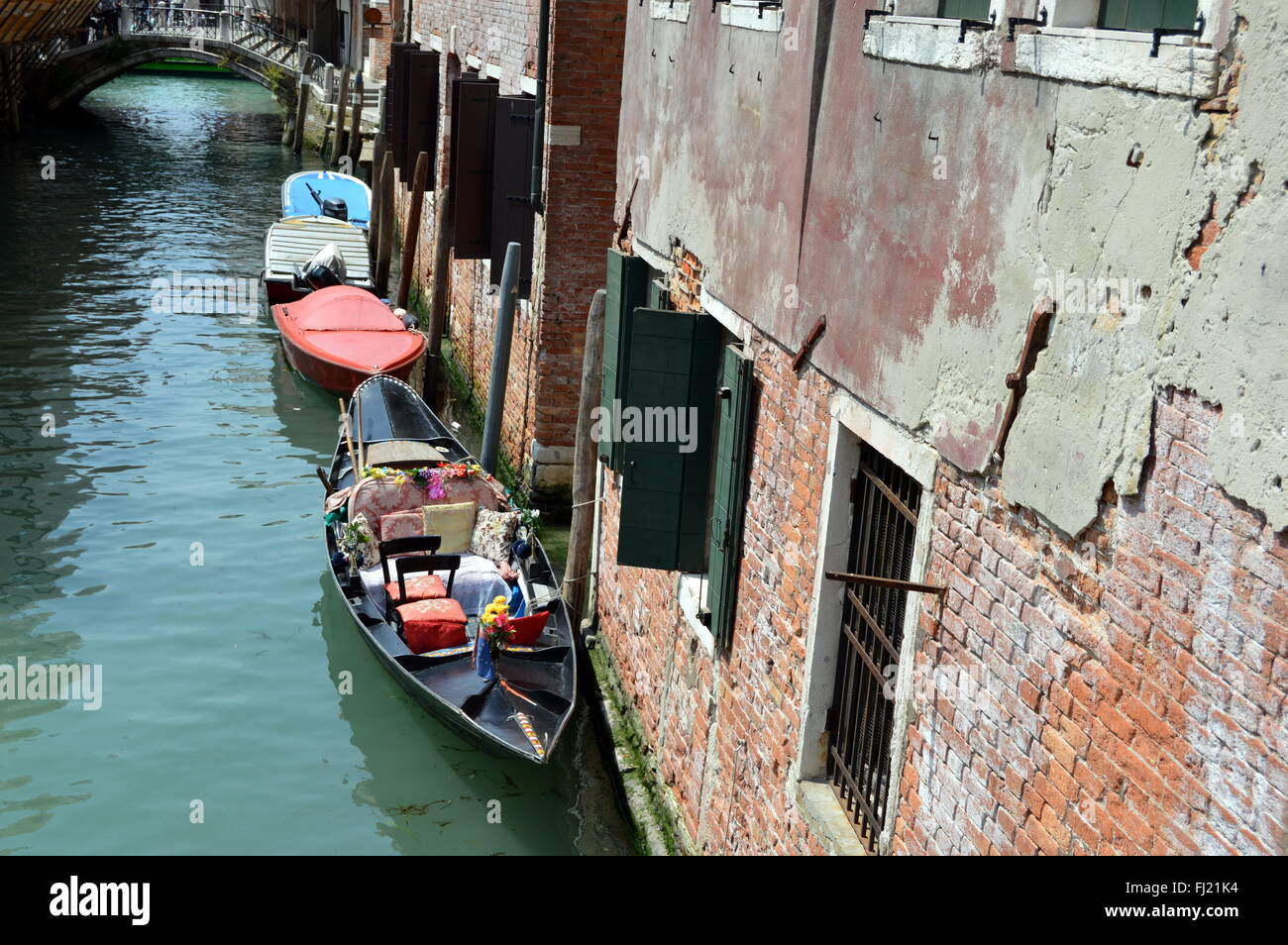 Boats outside homes in a channel in Venice, Italy Stock Photo - Alamy