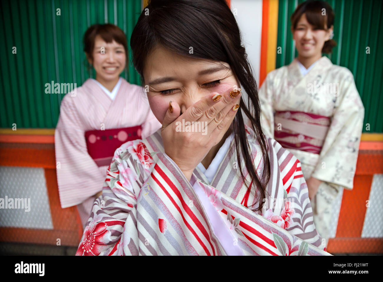 Three young japanese girls are having fun and smile at the Yasaka ...