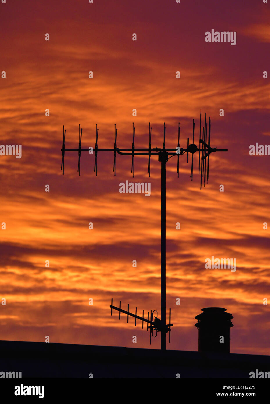 Rooftop Television aerials with sunset sky Stock Photo - Alamy