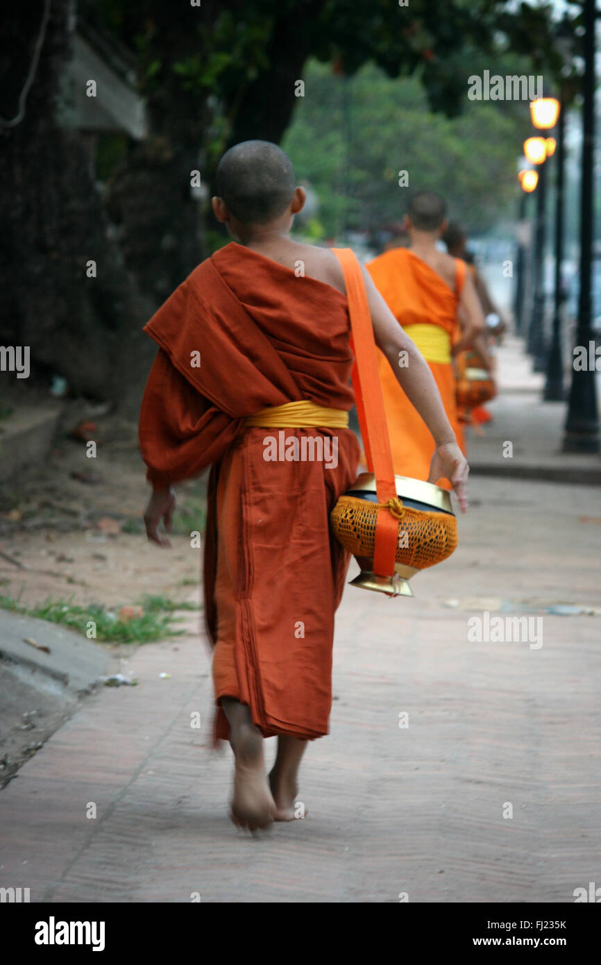 Buddhist monk walking in the streets of in Luang Prabang , Laos, Asia ...