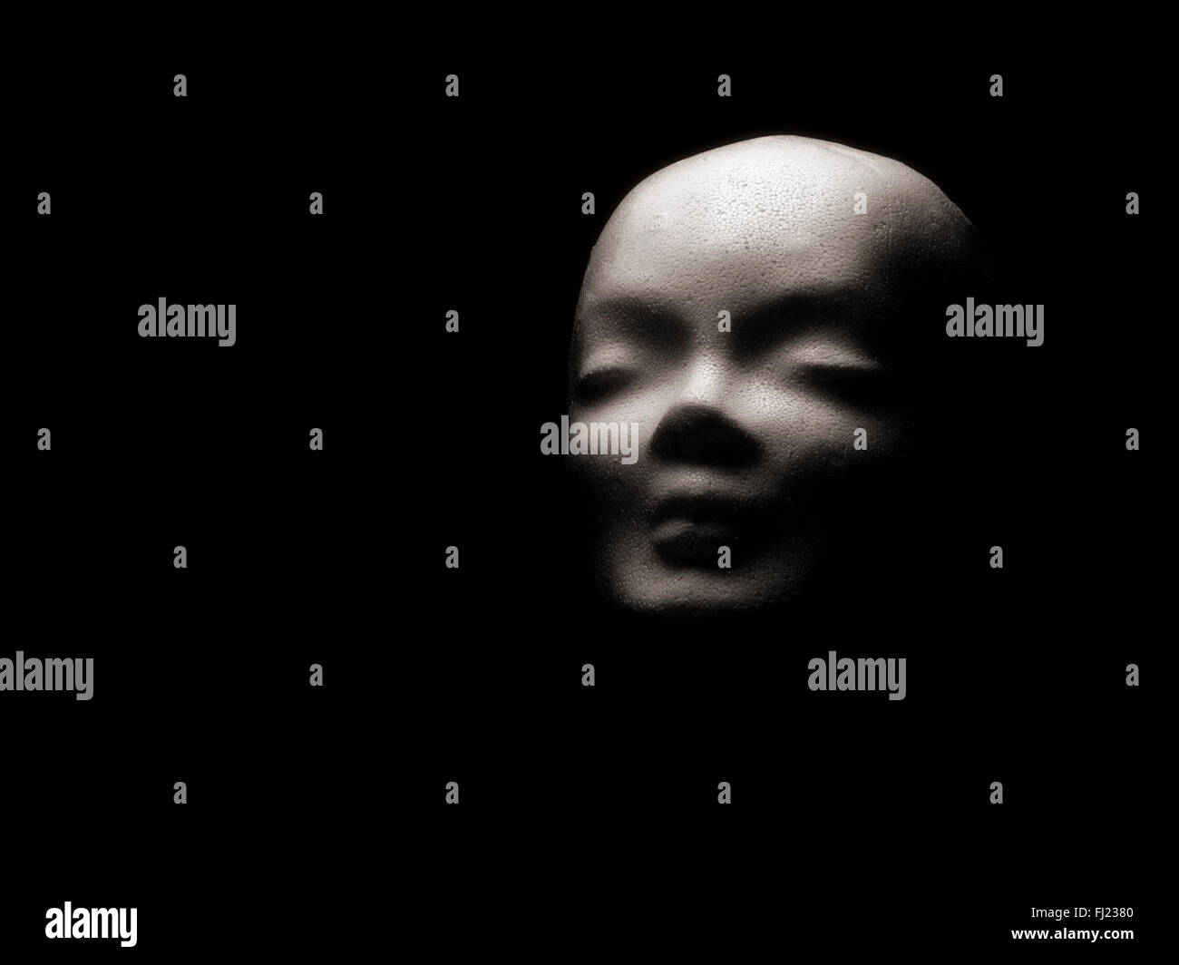 White dummy female head on black background Stock Photo - Alamy