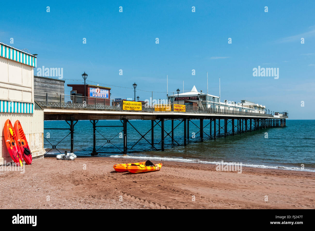 Paignton Pier reaches over a blue sea towards the horizon with cast ...