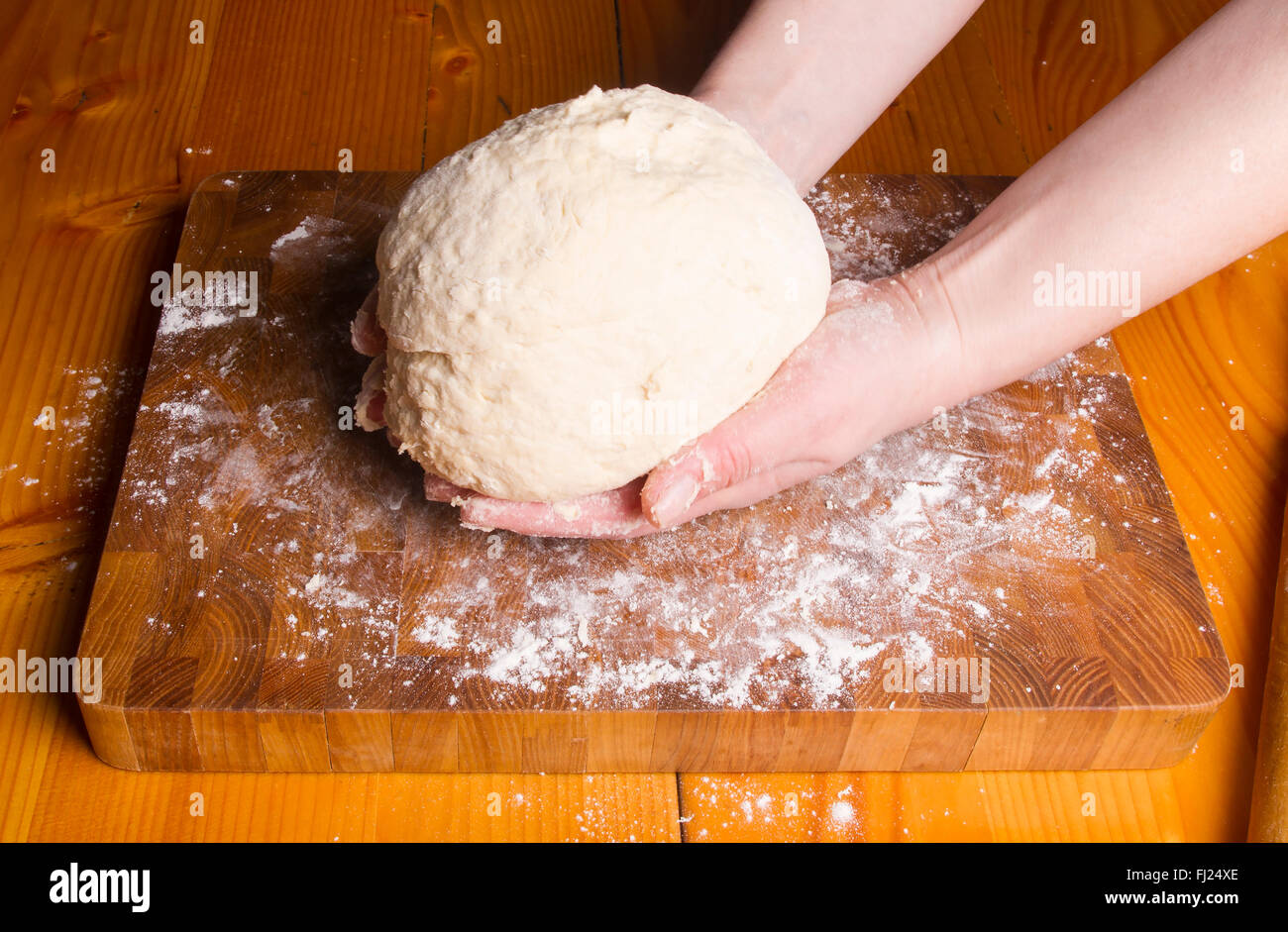 Making dough by female hands on wooden table background Stock Photo - Alamy