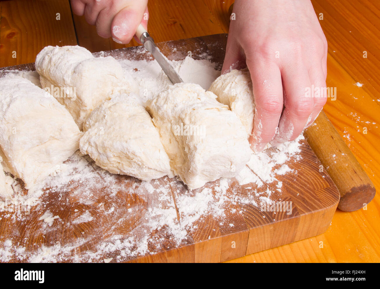Making dough by female hands on wooden table background Stock Photo - Alamy