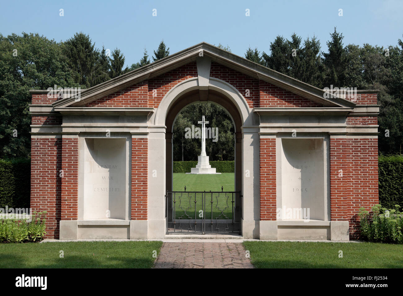 Entrance arch and Cross of Sacrifice in the CWGC Venray War Cemetery ...