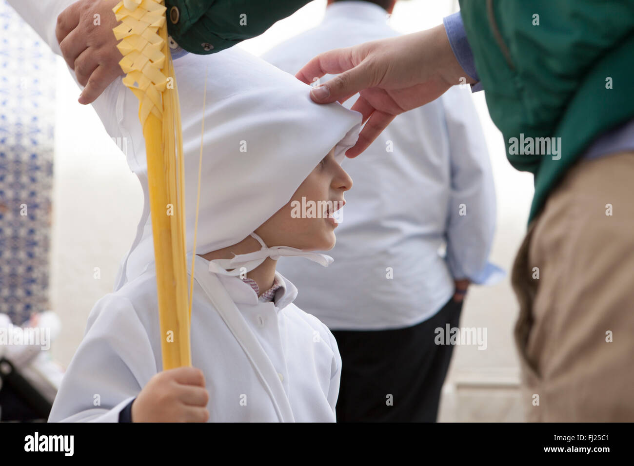 ALMENDRALEJO, SPAIN, MARCH 29: placing the hat to young nazareno at ...