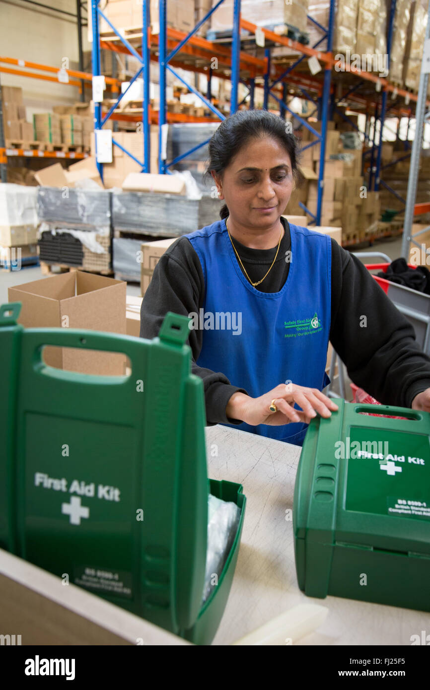 Woman packing First Aid Kit Boxes in a Warehouse in Hendon, England ...