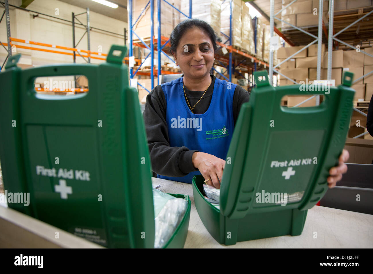 Woman packing First Aid Kit Boxes in a Warehouse in Hendon, England ...