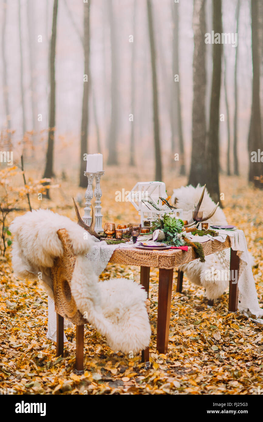 Table decorated in the scandinavian style with deer horns and pelts on ...