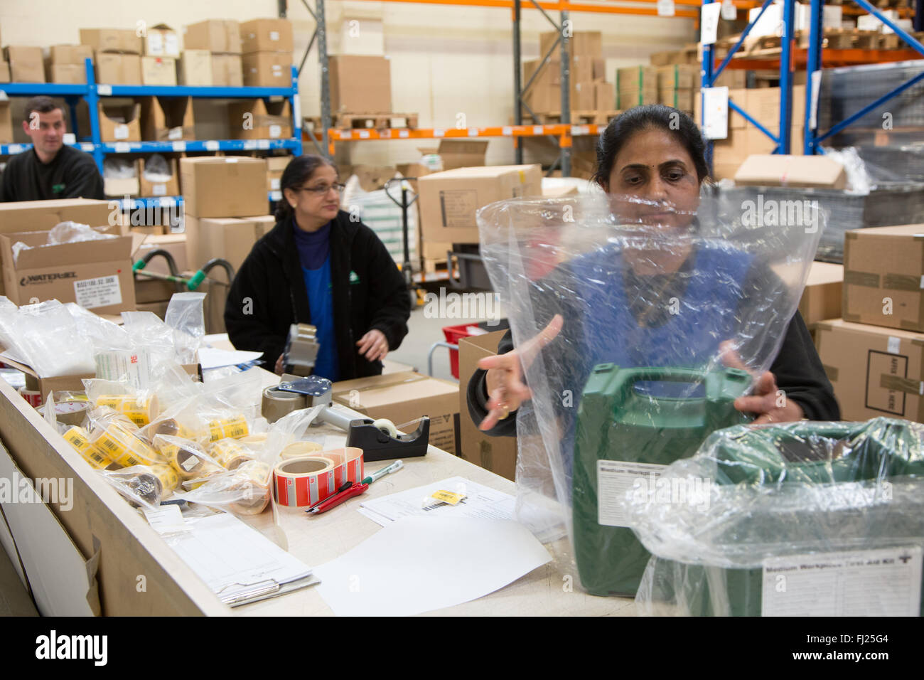 Factory workers pack boxes of First Aid kits in Hendon, England Stock ...