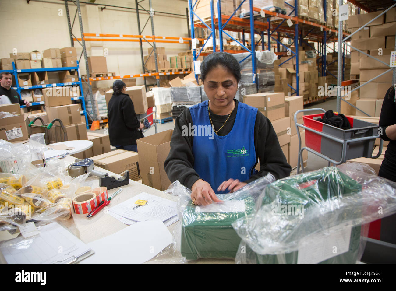 Factory workers pack boxes of First Aid kits in Hendon, England Stock ...