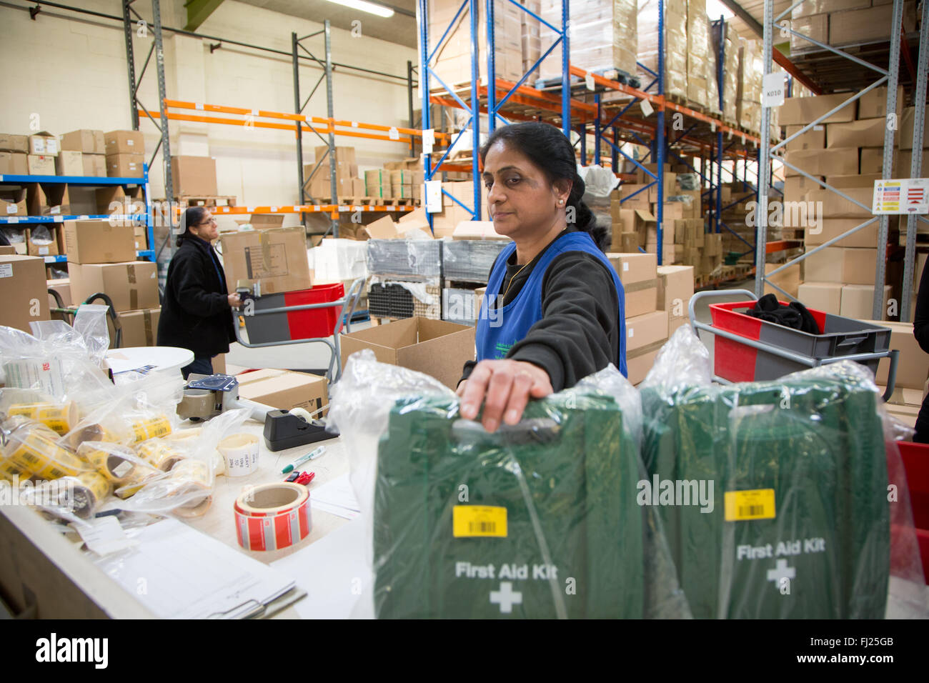 Factory workers pack boxes of First Aid kits in Hendon, England Stock ...