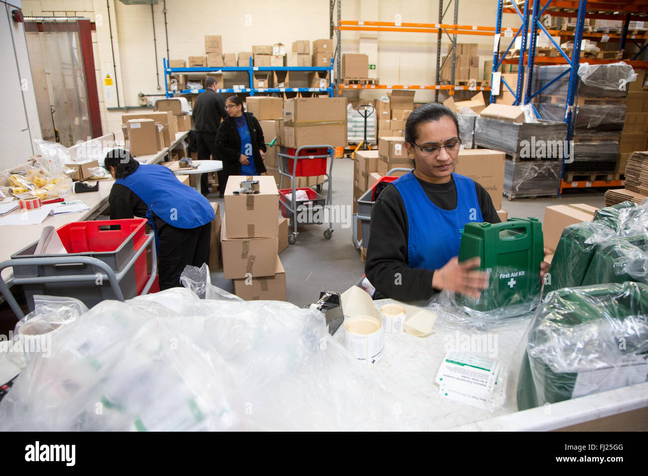 Factory workers pack boxes of First Aid kits in Hendon, London, England ...