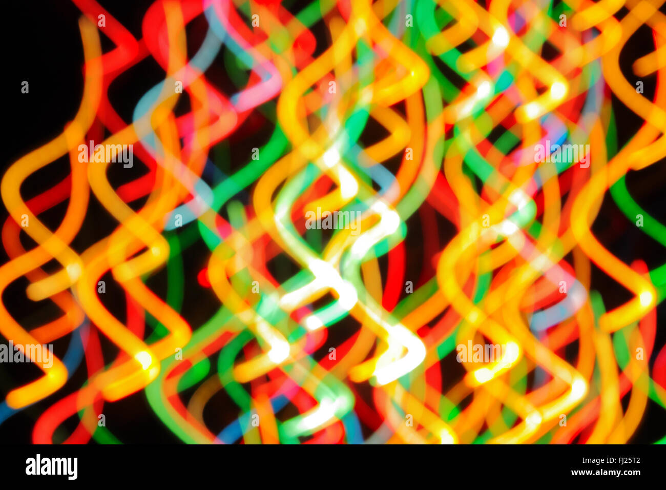 Multi-colored strips of light against a black background Stock Photo ...