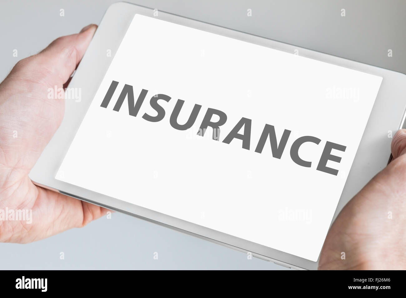 Insurance text displayed on touchscreen of modern tablet or smart ...