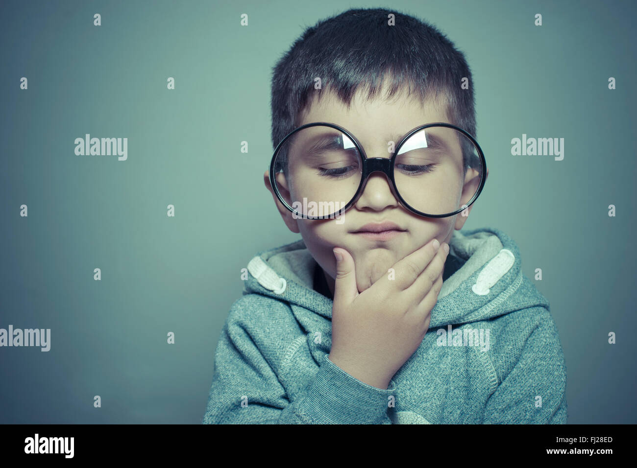 thinking, boy with big glasses very serious and thinking Stock Photo ...