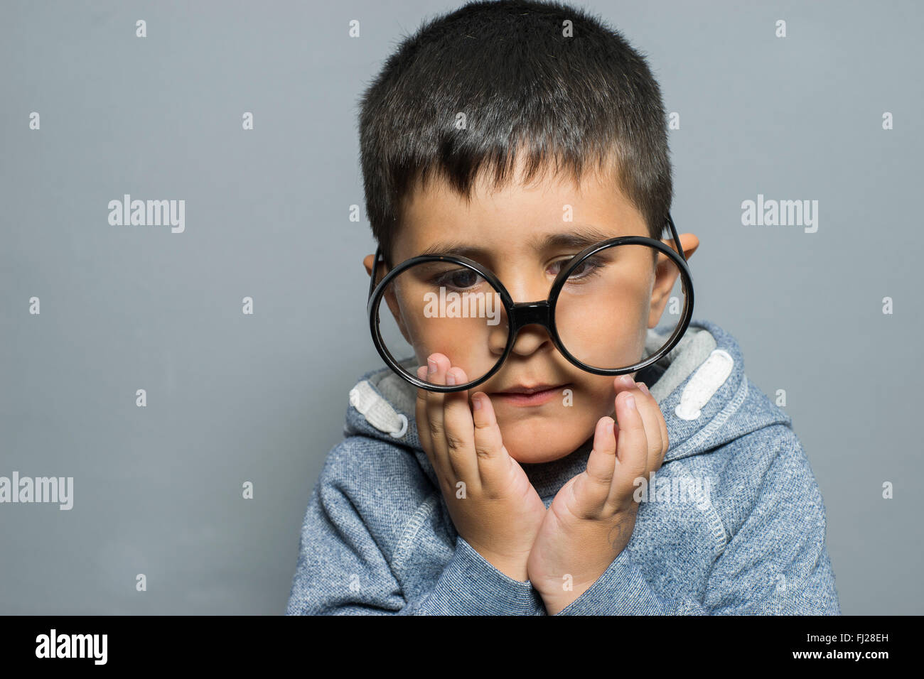 thinking, boy with big glasses very serious and thinking Stock Photo ...