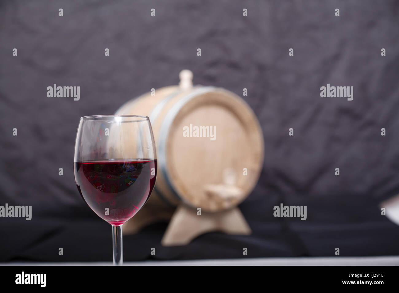 A barrel of alcohol on a black background Stock Photo - Alamy
