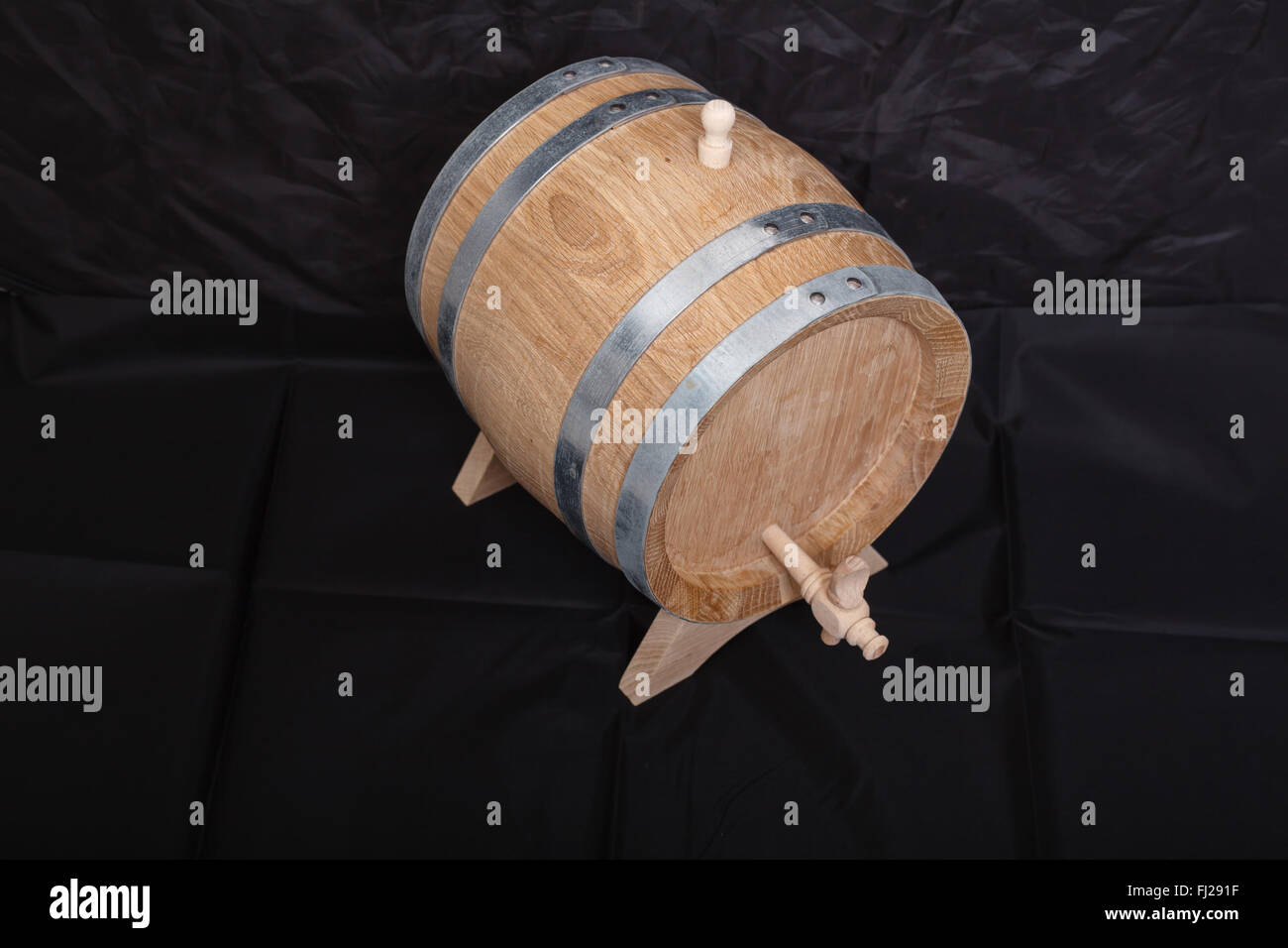A barrel of alcohol on a black background Stock Photo - Alamy