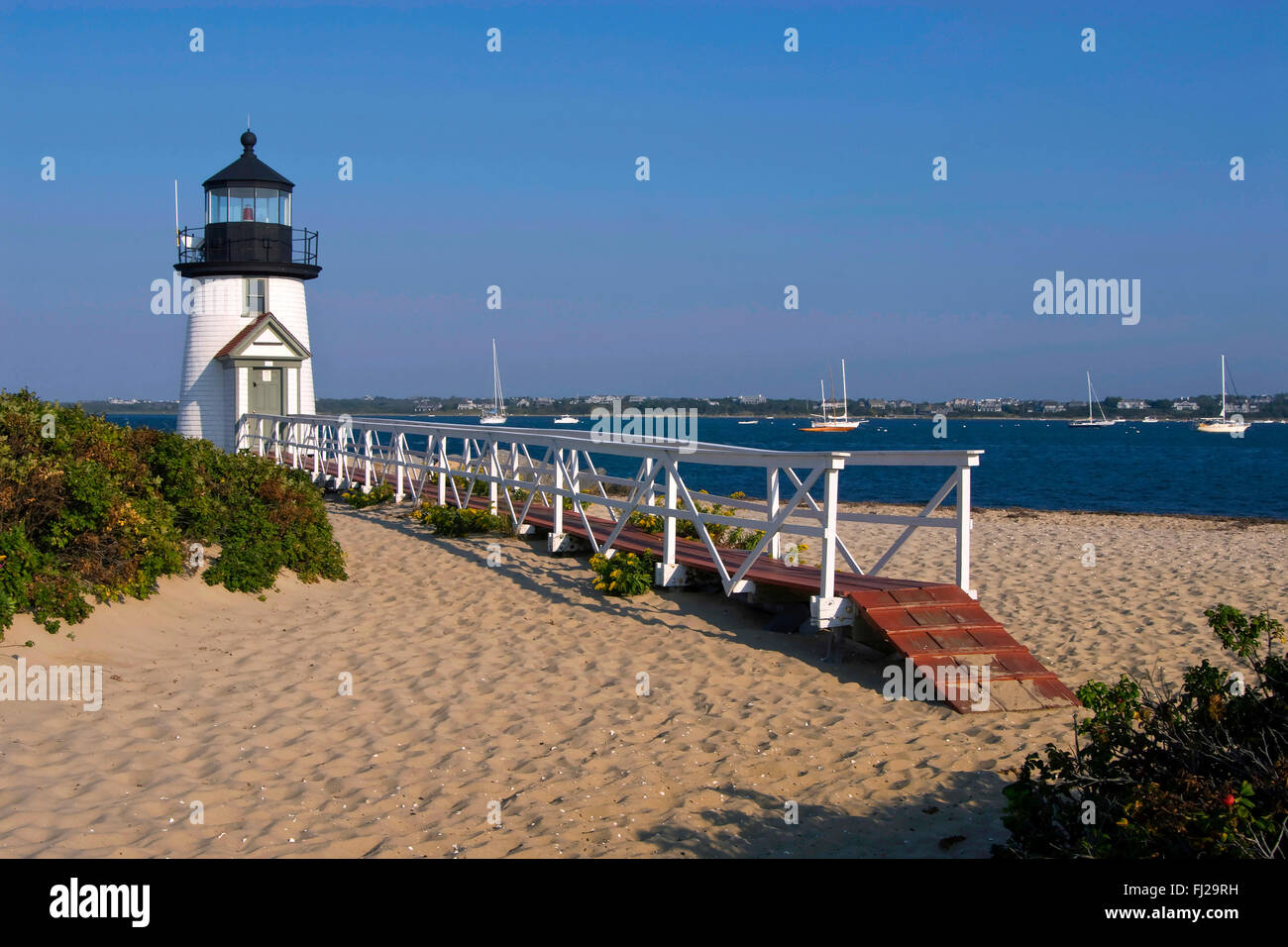 Bridge walkway leads to Brant Point lighthouse wooden tower, on ...