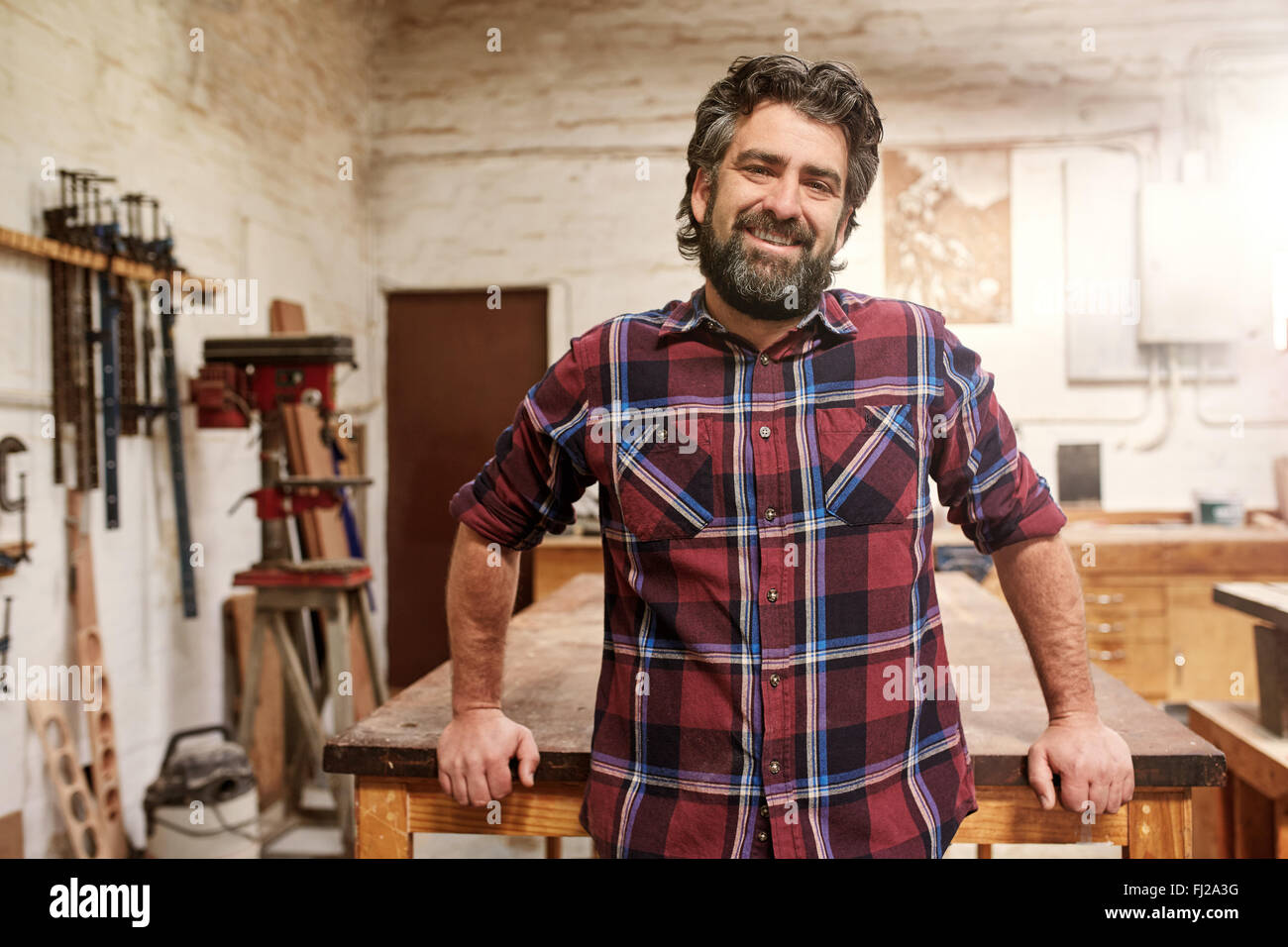Smiling bearded craftsman in his woodwork studio Stock Photo - Alamy